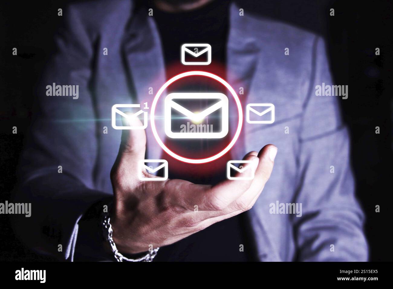 A businessman's hand presenting a floating email notification icon ...