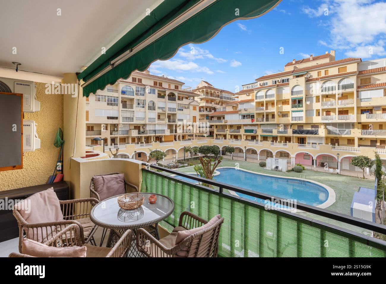 Cozy balcony with wicker furniture overlooking a Mediterranean-style ...