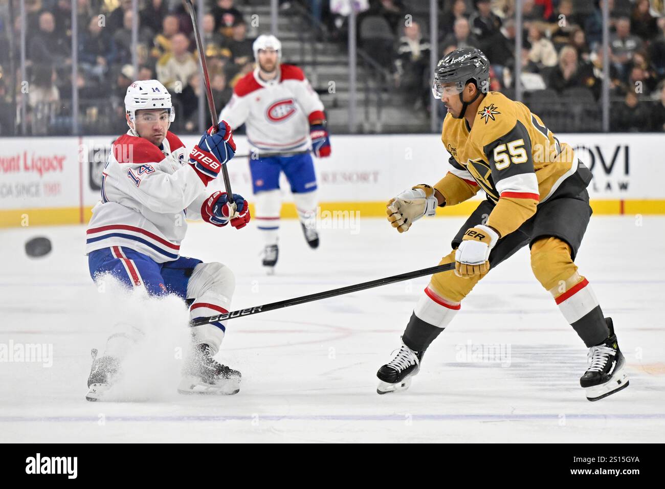 Montreal Canadiens center Nick Suzuki (14) hits the puck down ice ...