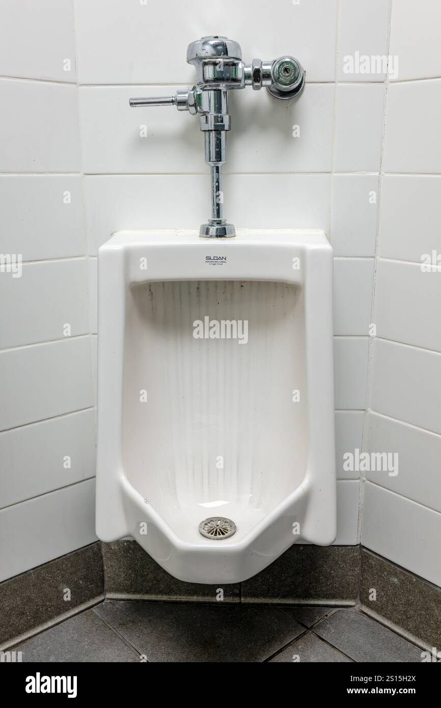 Men's Sloan urinal in a public restroom, bathroom, or men's room in ...