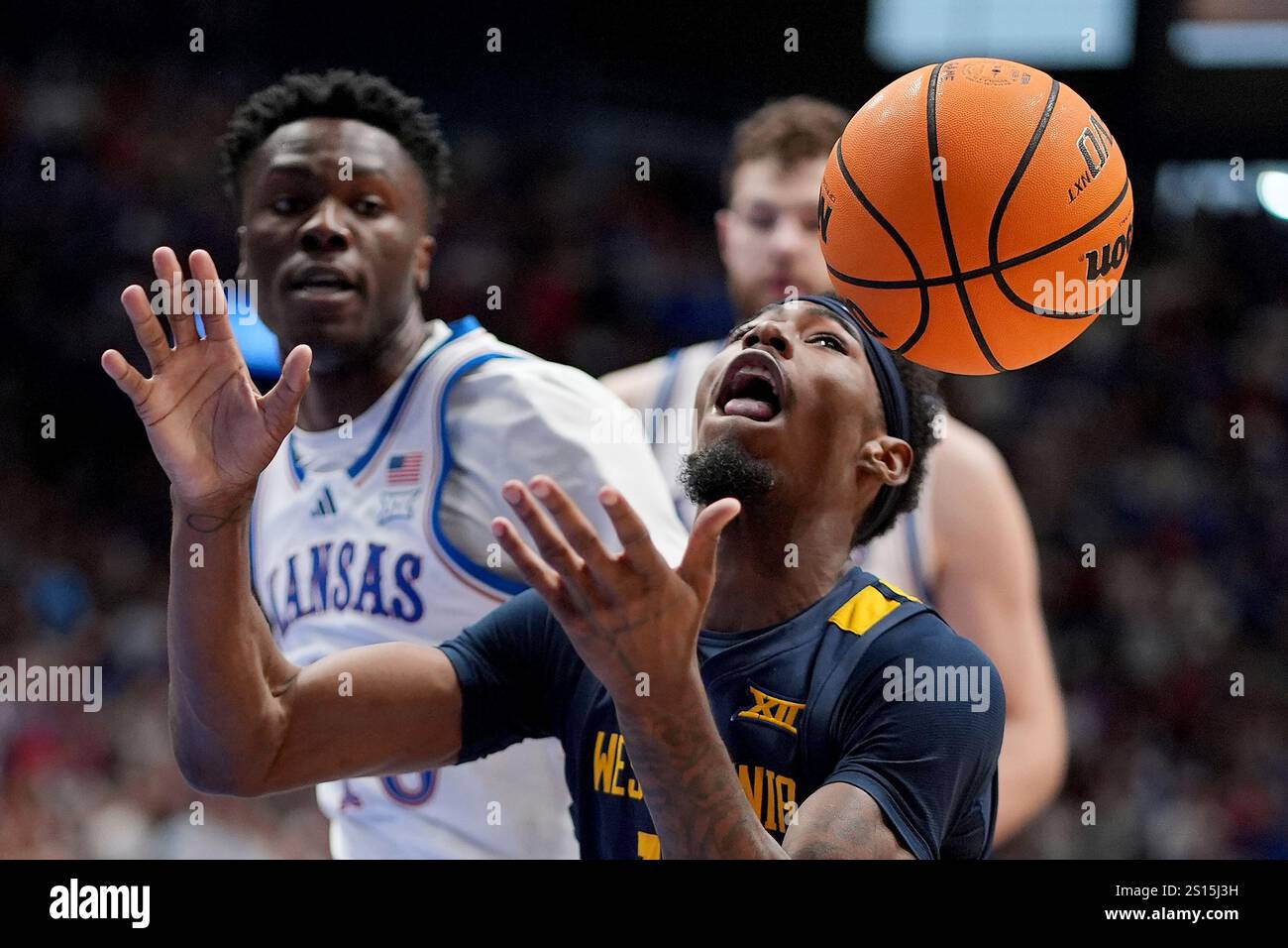 West Virginia guard Sencire Harris, front, chases a loose ball during ...