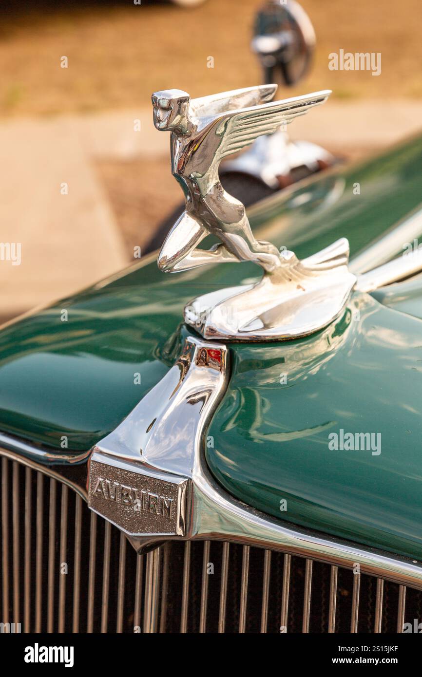 A chrome "flying lady" hood ornament on an antique green Auburn ...