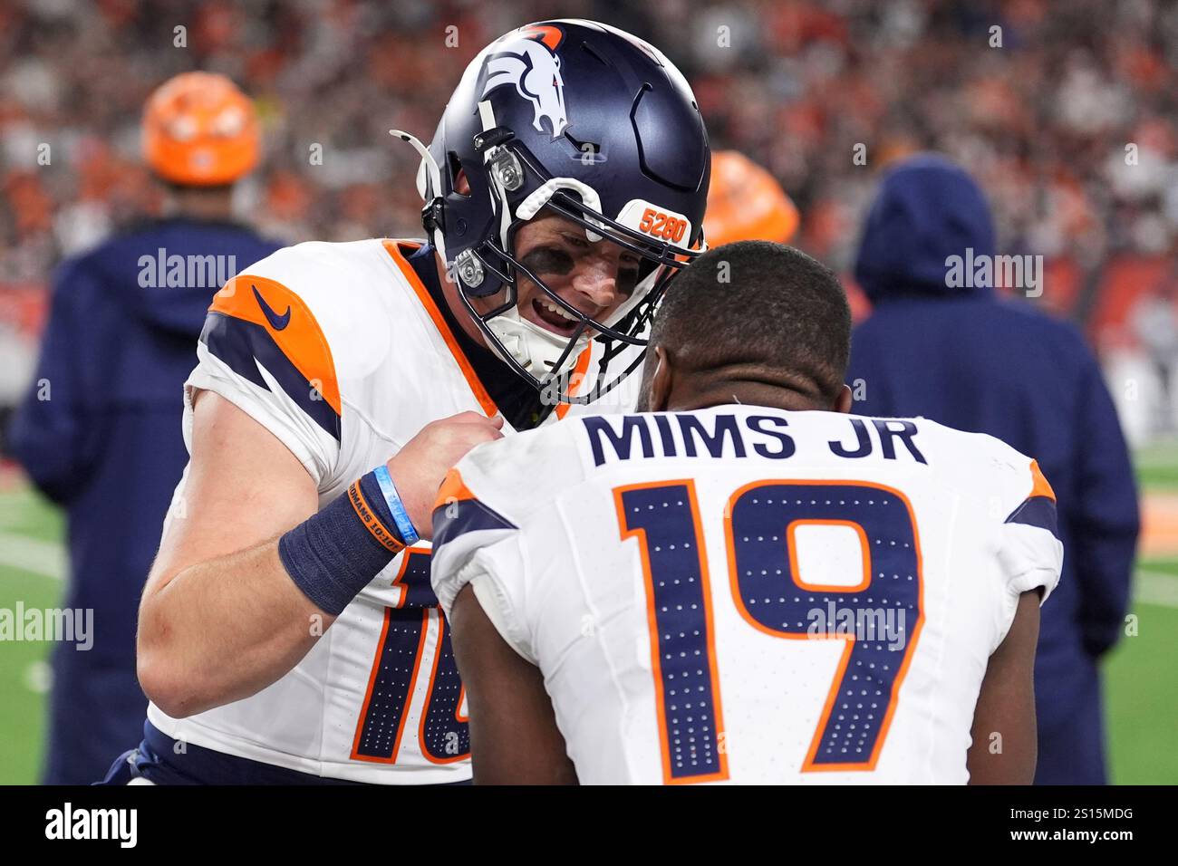 Denver Broncos quarterback Bo Nix talks with Denver Broncos wide receiver Marvin Mims Jr. on the ...