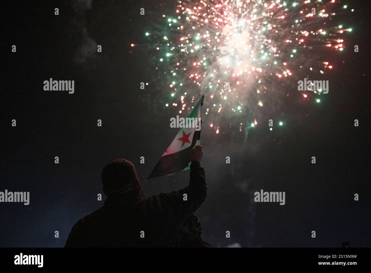A man waves a Syrian "revolutionary" flag during New Year's Eve ...