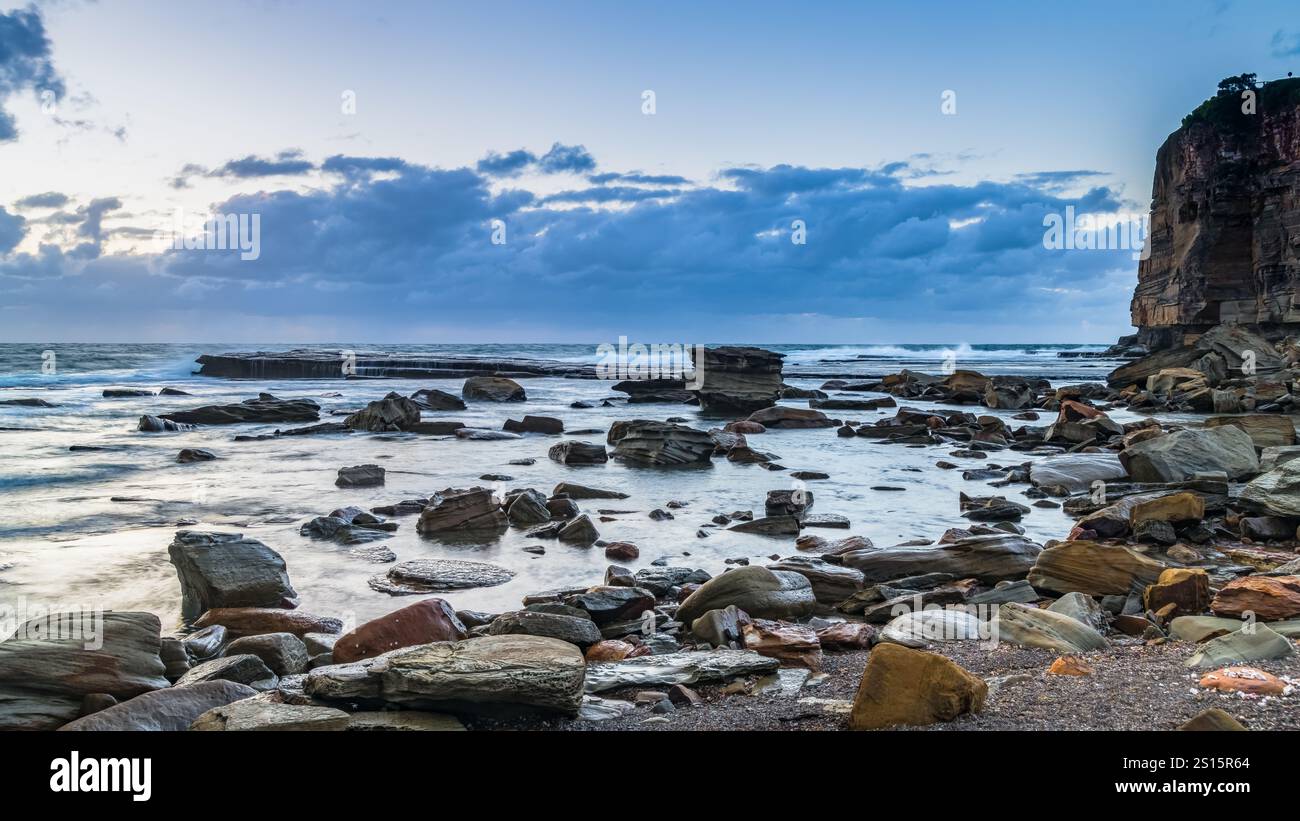 Autumn sunrise seascape with clouds and rocks at The Skillion in ...
