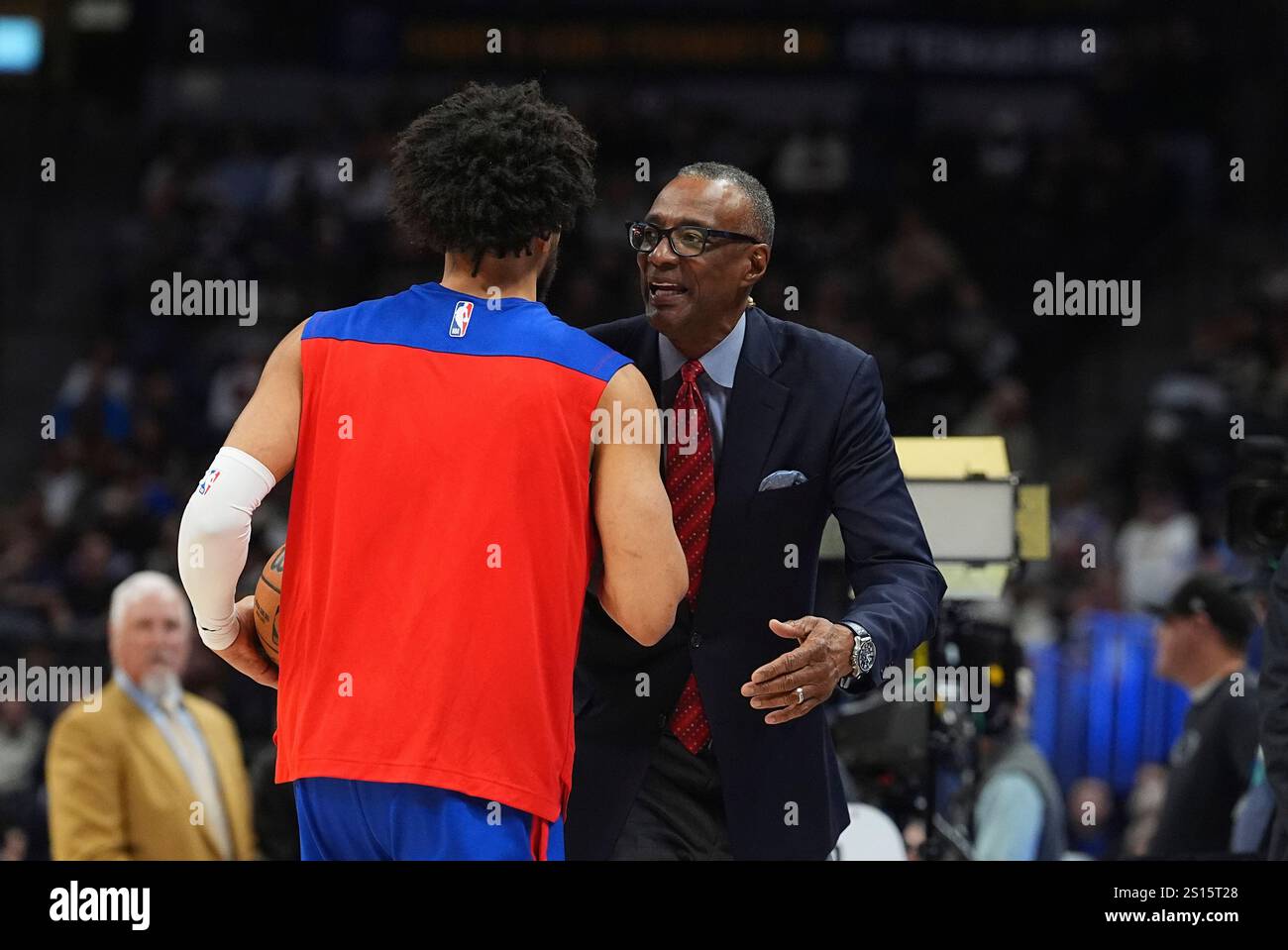 Detroit Pistons guard Cade Cunningham (2) greets television announcer ...