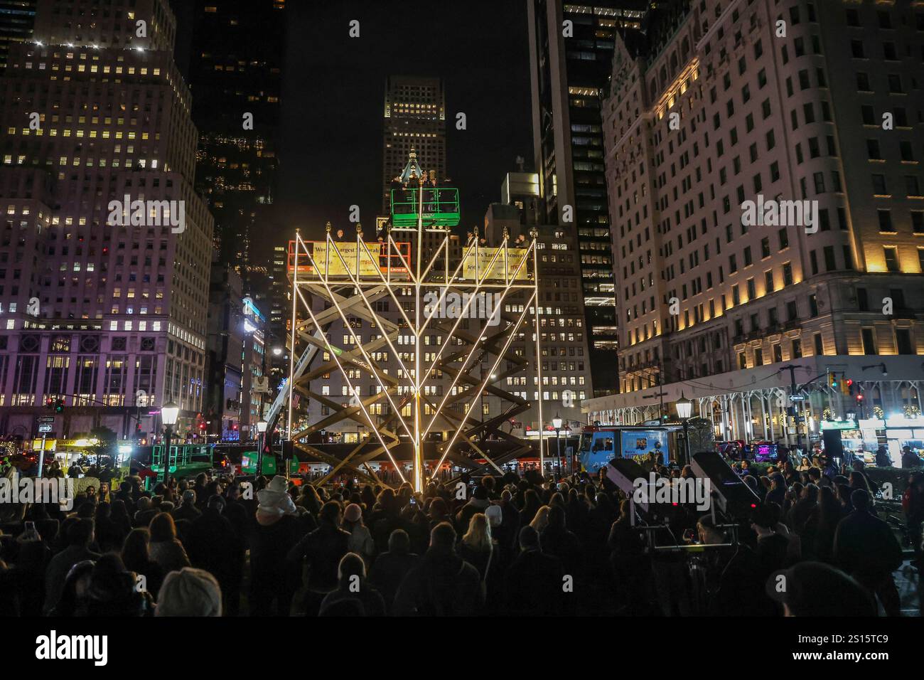 The crowd watches the lighting of the world's largest menorah on Fifth ...