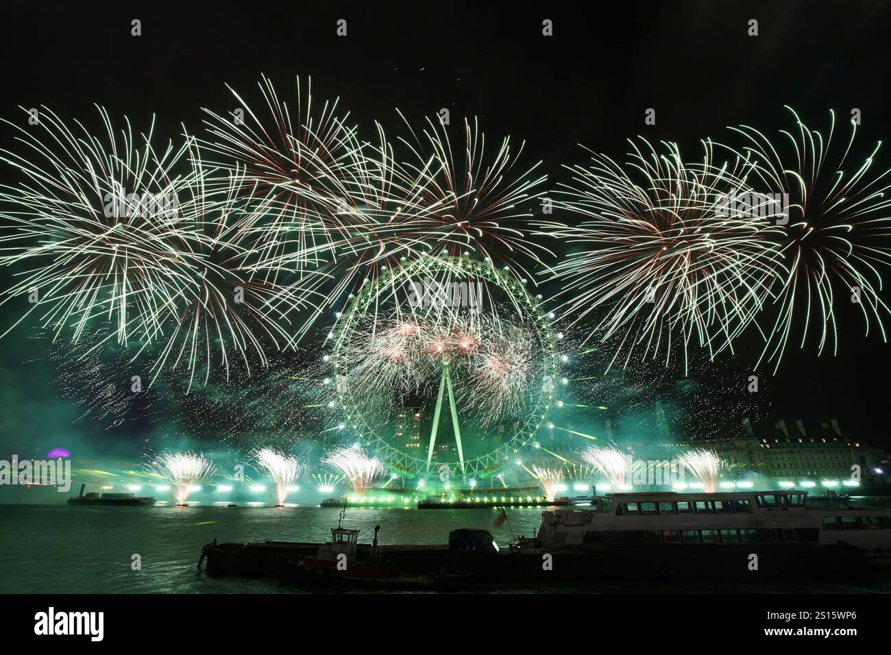 Fireworks light up the sky around the London Eye on the south bank of ...