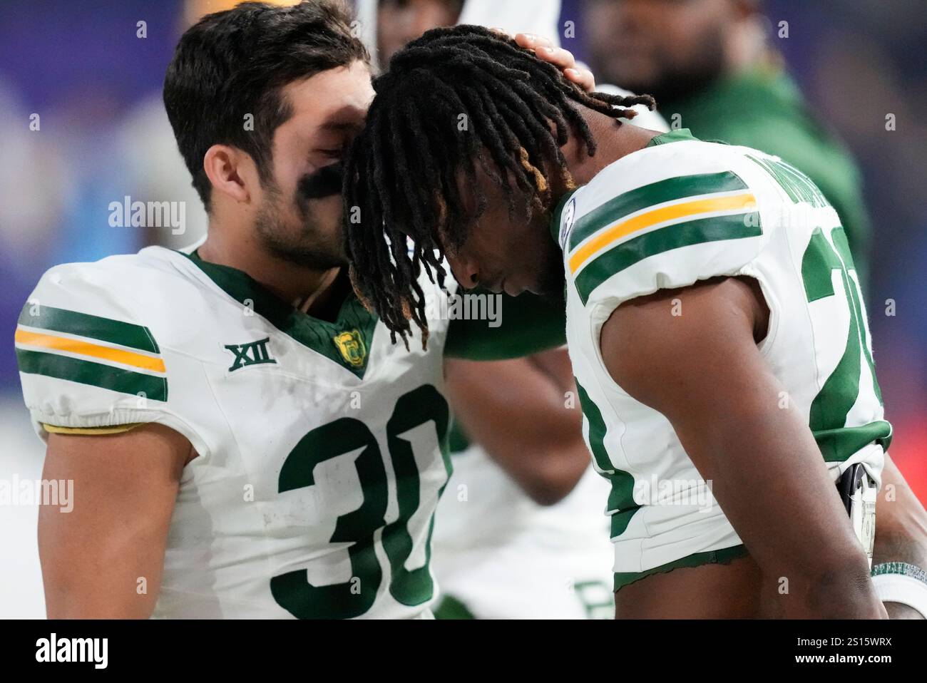 Baylor Bears safety Kris Wokomah, right, is comforted by a teammate ...