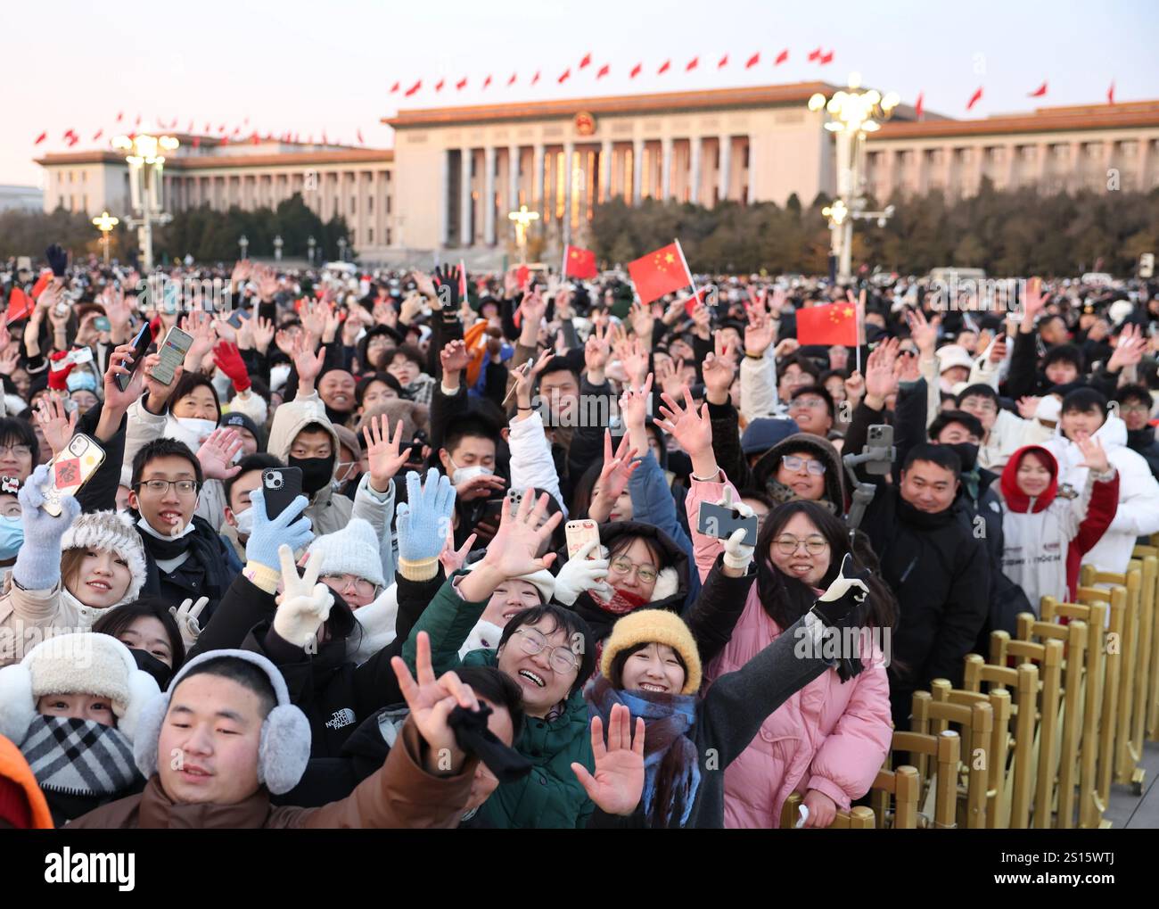 Beijing, China. 1st Jan, 2025. People hail after a grand national flag ...
