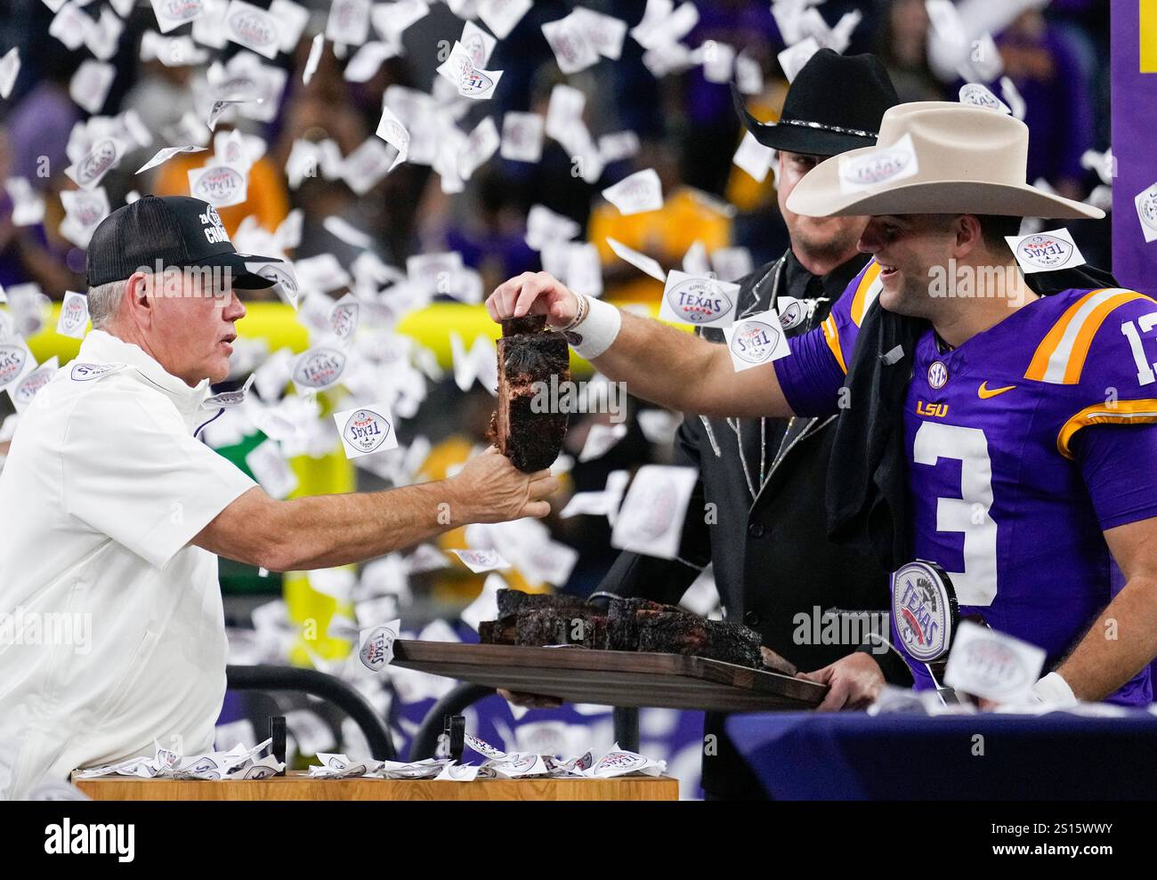 LSU head coach Brian Kelly, left, hands a rib to quarterback Garrett ...