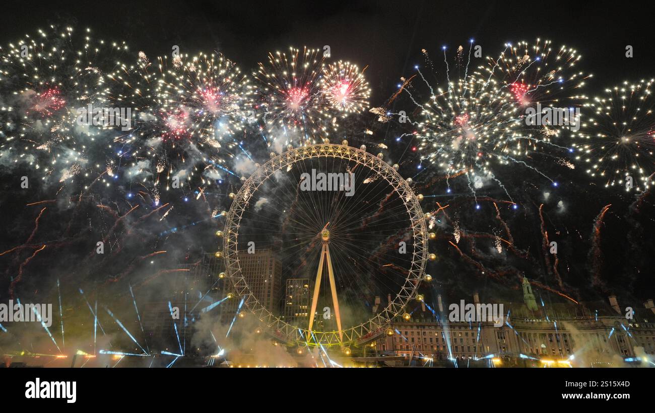 Fireworks light up the sky over the London Eye in central London during ...