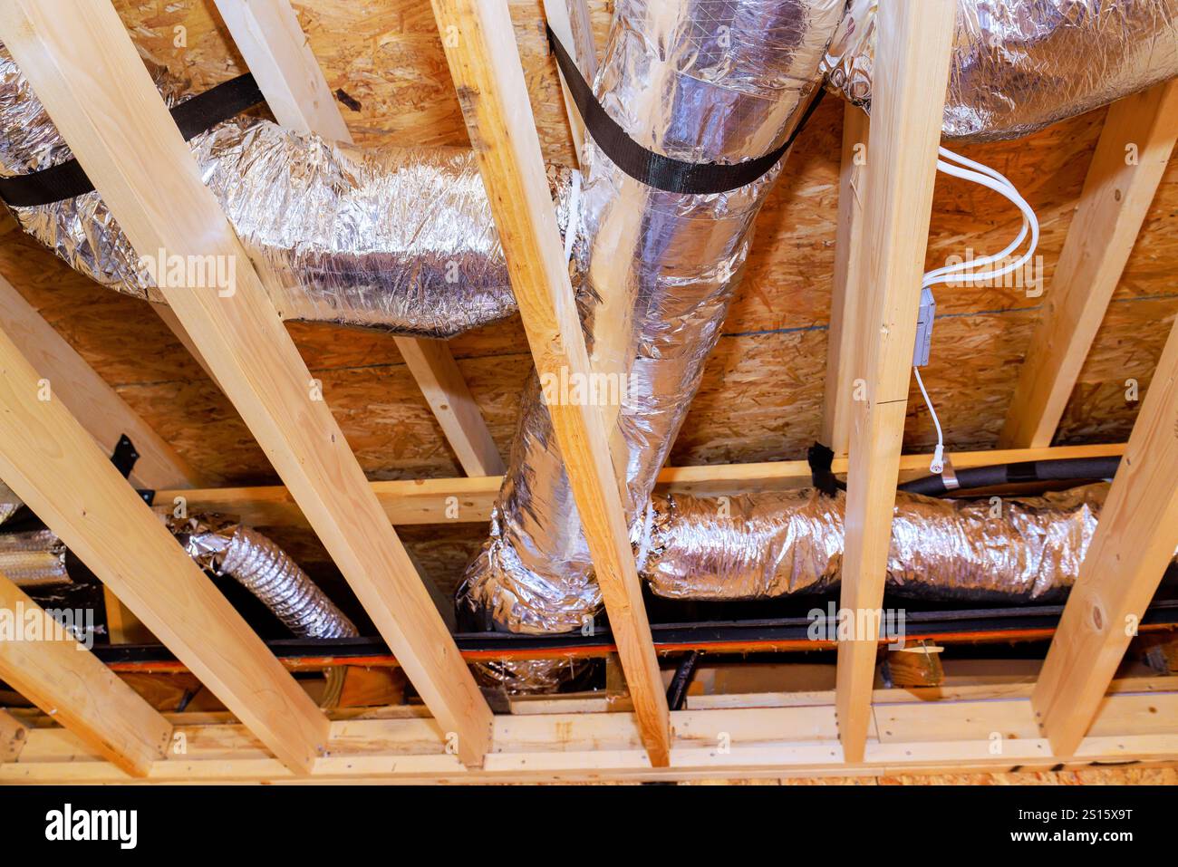Ducts are being installed in ceiling structure of new building under ...