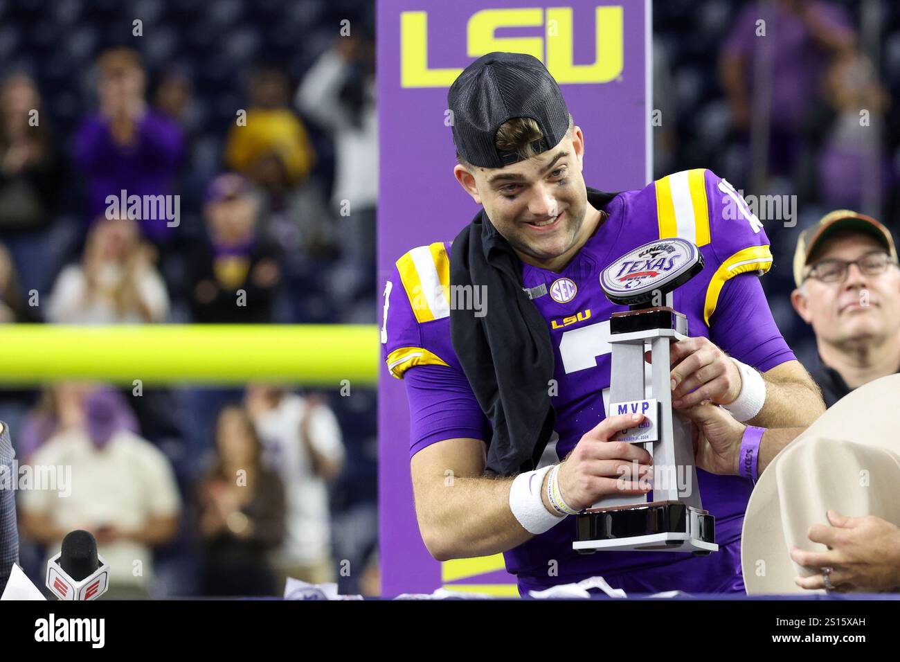 HOUSTON, TX - DECEMBER 31: LSU Tigers quarterback Garrett Nussmeier (13) accepts the MVP trophy ...