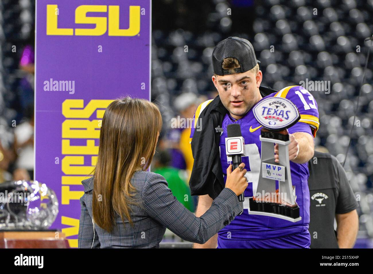 HOUSTON, TX - DECEMBER 31: LSU Tigers quarterback Garrett Nussmeier (13) holds the MVP trophy ...