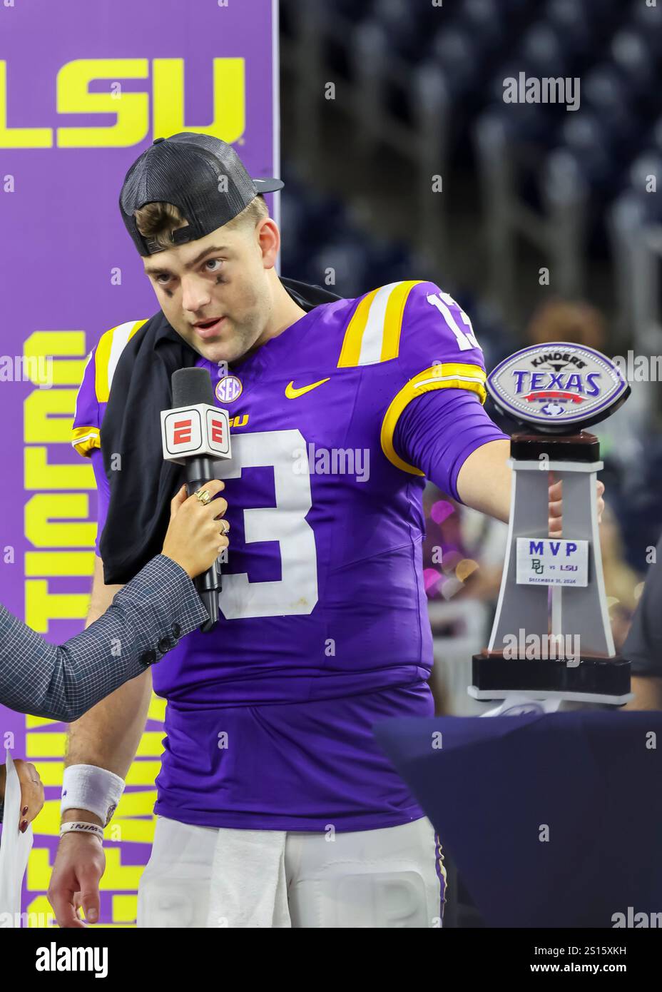HOUSTON, TX - DECEMBER 31: LSU Tigers quarterback Garrett Nussmeier (13) holds up his MVP trophy ...