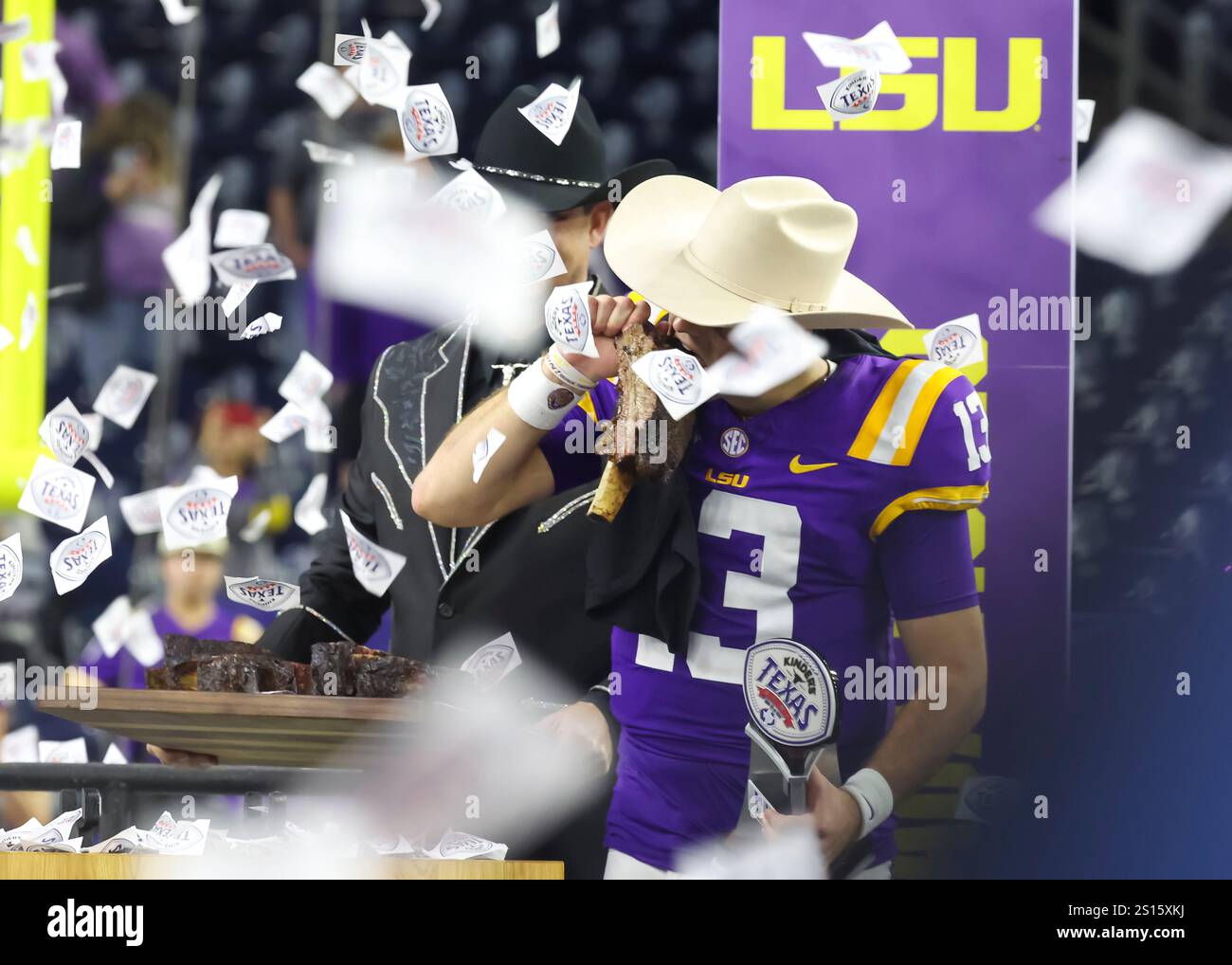 HOUSTON, TX - DECEMBER 31: LSU Tigers quarterback Garrett Nussmeier (13) takes a bite from the ...