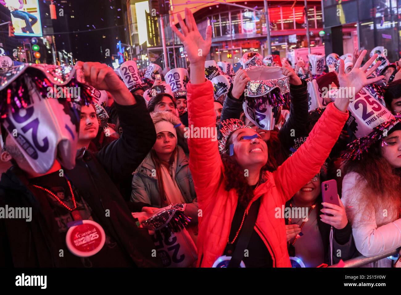 Revelers catch confetti from a performance during the annual New Year's ...