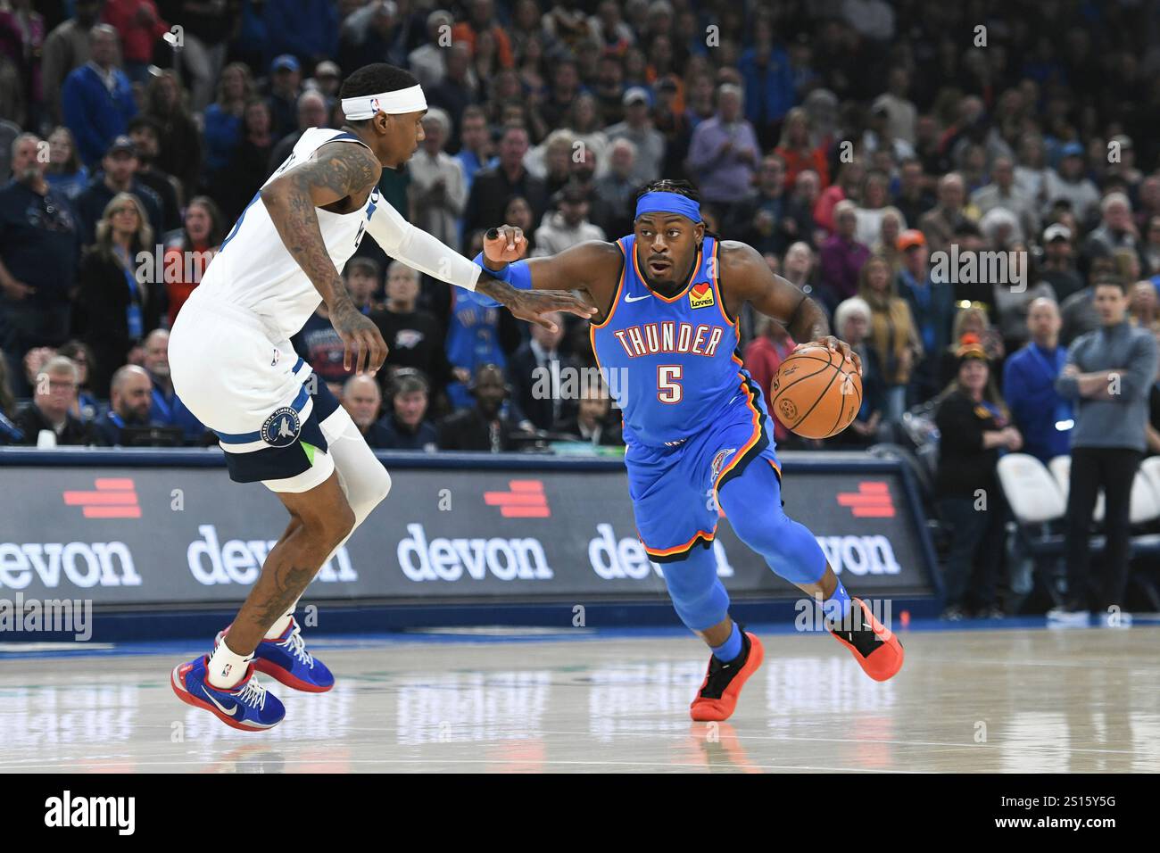 Oklahoma CIty Thunder guard Luguentz Dort, right, drives past Minnesota ...