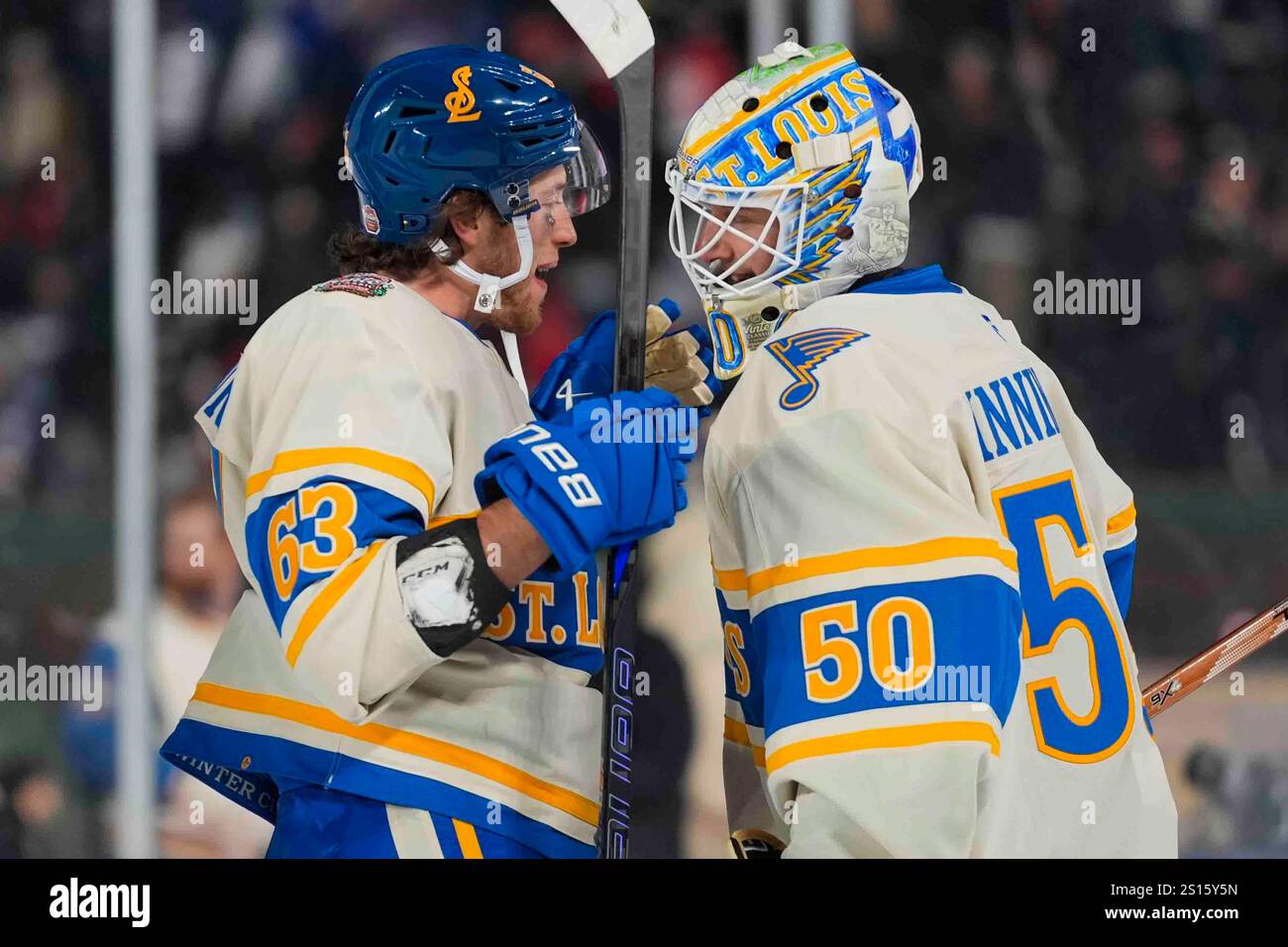 St. Louis Blues left wing Jake Neighbours (63) and goaltender Jordan ...