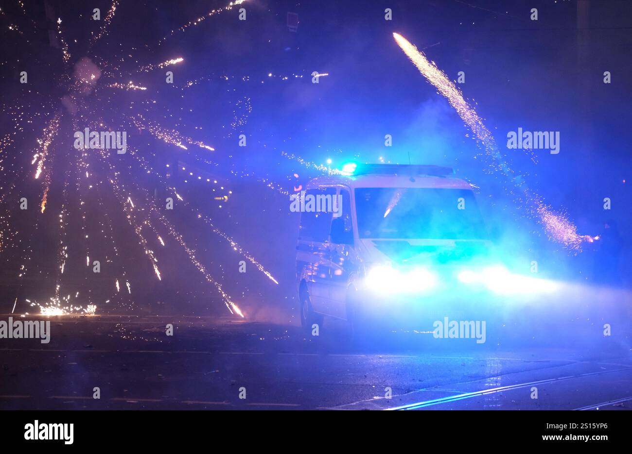 01 January 2025, Saxony, Leipzig: Pyrotechnics are thrown at a police ...