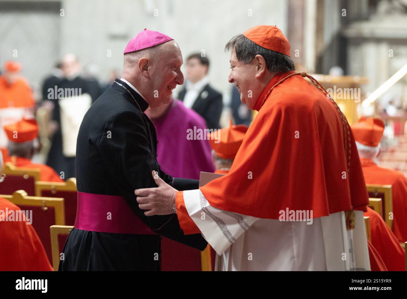 A cardinal and a bishop greet each other before the start of the end-of ...