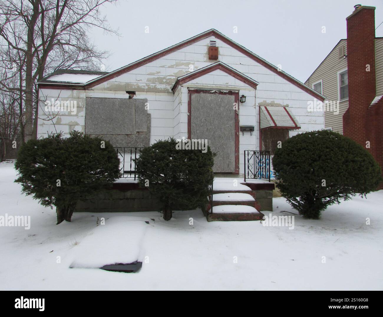 Abandoned and boarded bungalow home in winter in Flint, Michigan Stock ...