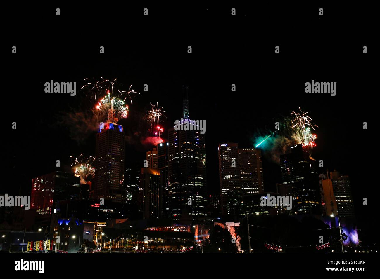 Fireworks light up Melbourne's cityscape, with Flinders Street Station and the Yarra River ...