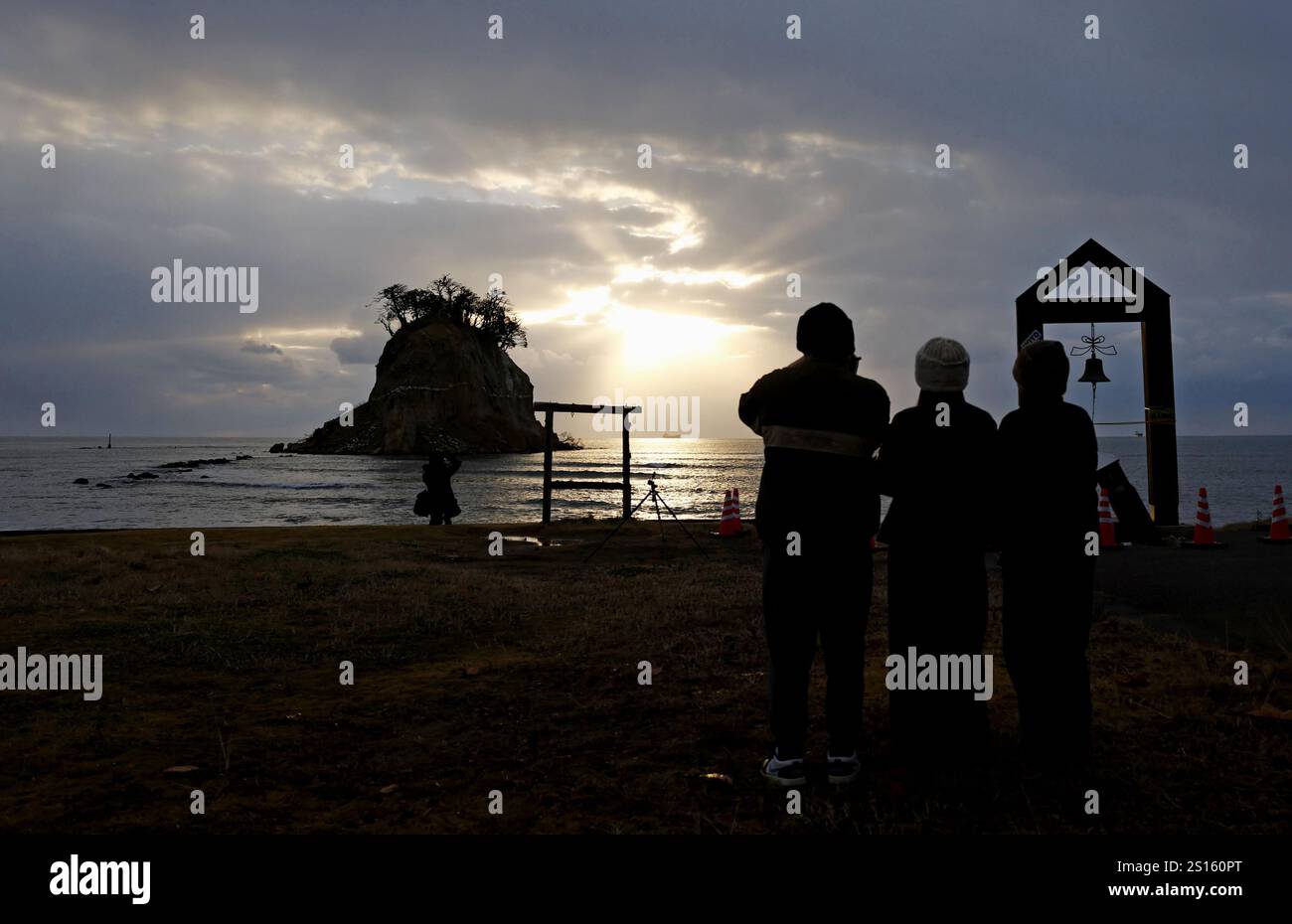 People stand on a shore in Suzu, Ishikawa Prefecture, on Jan. 1, 2025 ...