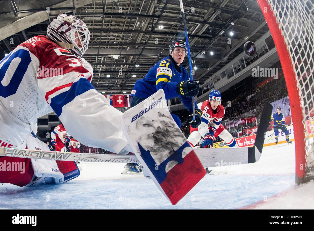 Herman Träff of, Sweden. , . scores 2-0 behind goaltender Michael ...