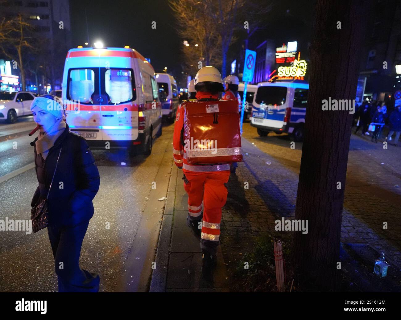Hamburg, Germany. 01st Jan, 2025. Paramedics walk across the Reeperbahn ...
