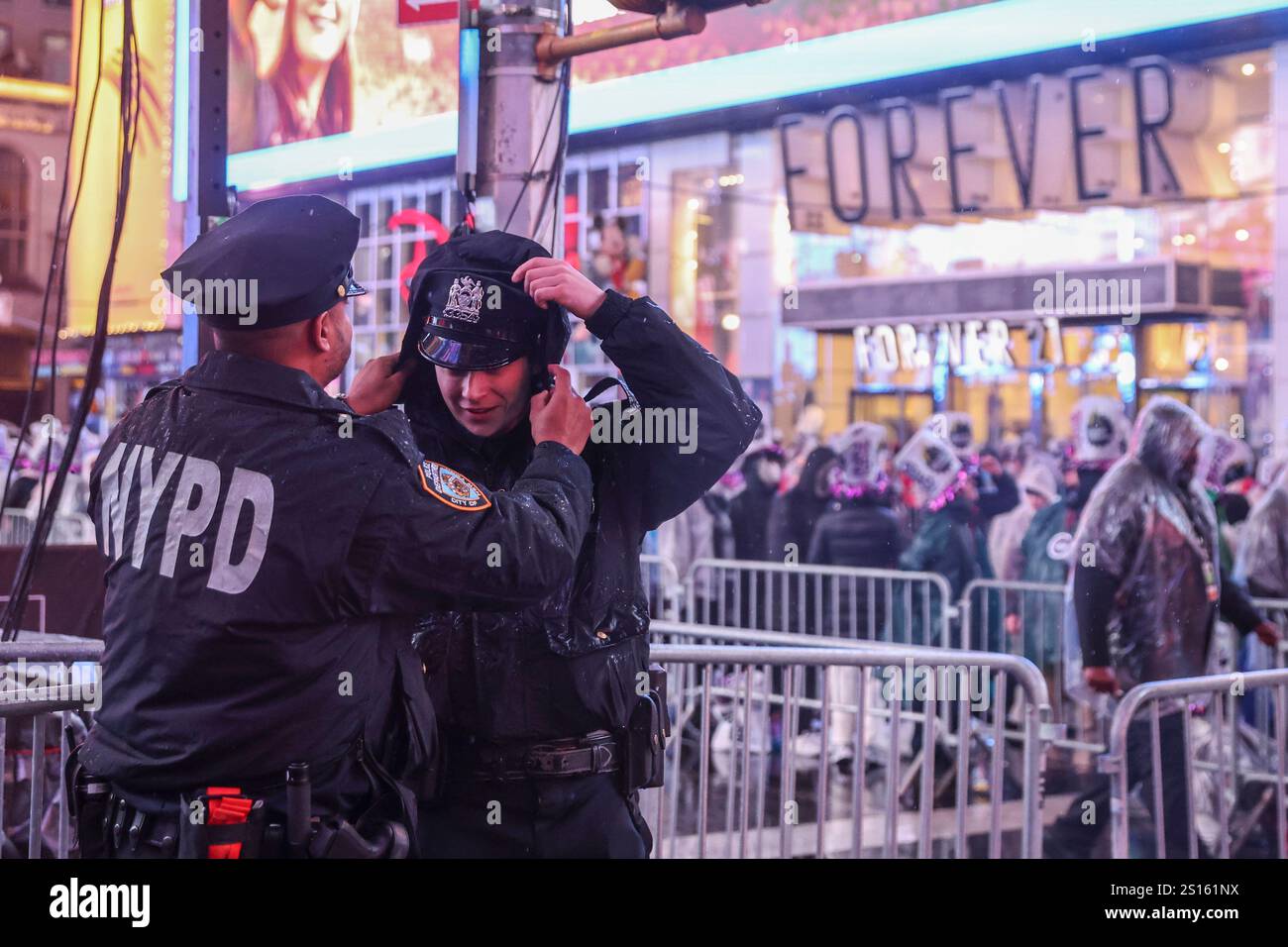 NYPD officers stand in the rain during the annual New Year's Eve ...