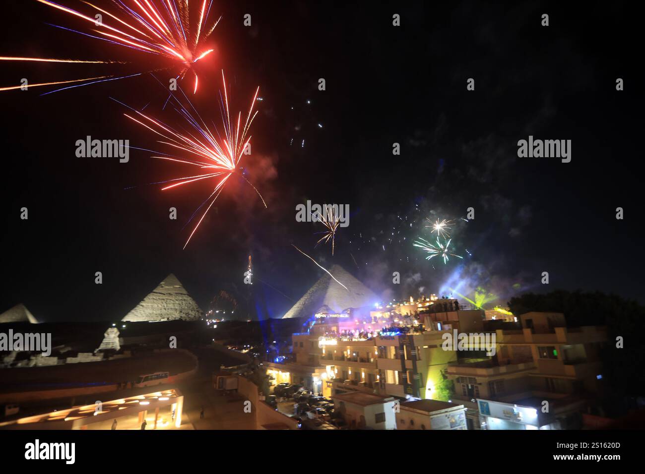 Cairo, Egypt. 31st Dec, 2024. Fireworks spark over the historical site ...