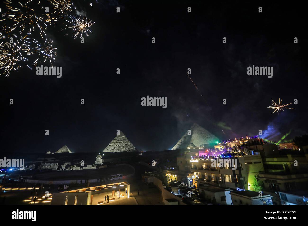 Cairo, Egypt. 31st Dec, 2024. Fireworks spark over the historical site ...