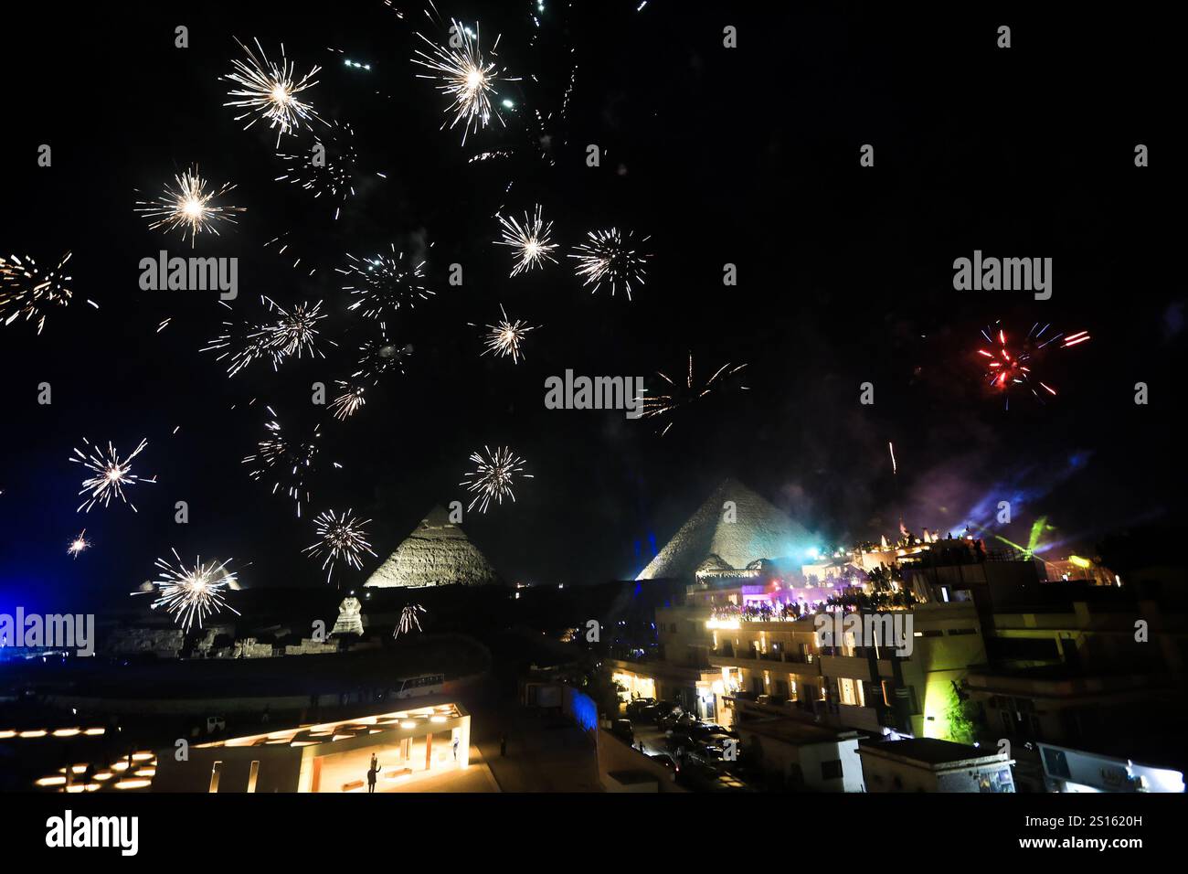 Cairo, Egypt. 31st Dec, 2024. Fireworks spark over the historical site ...