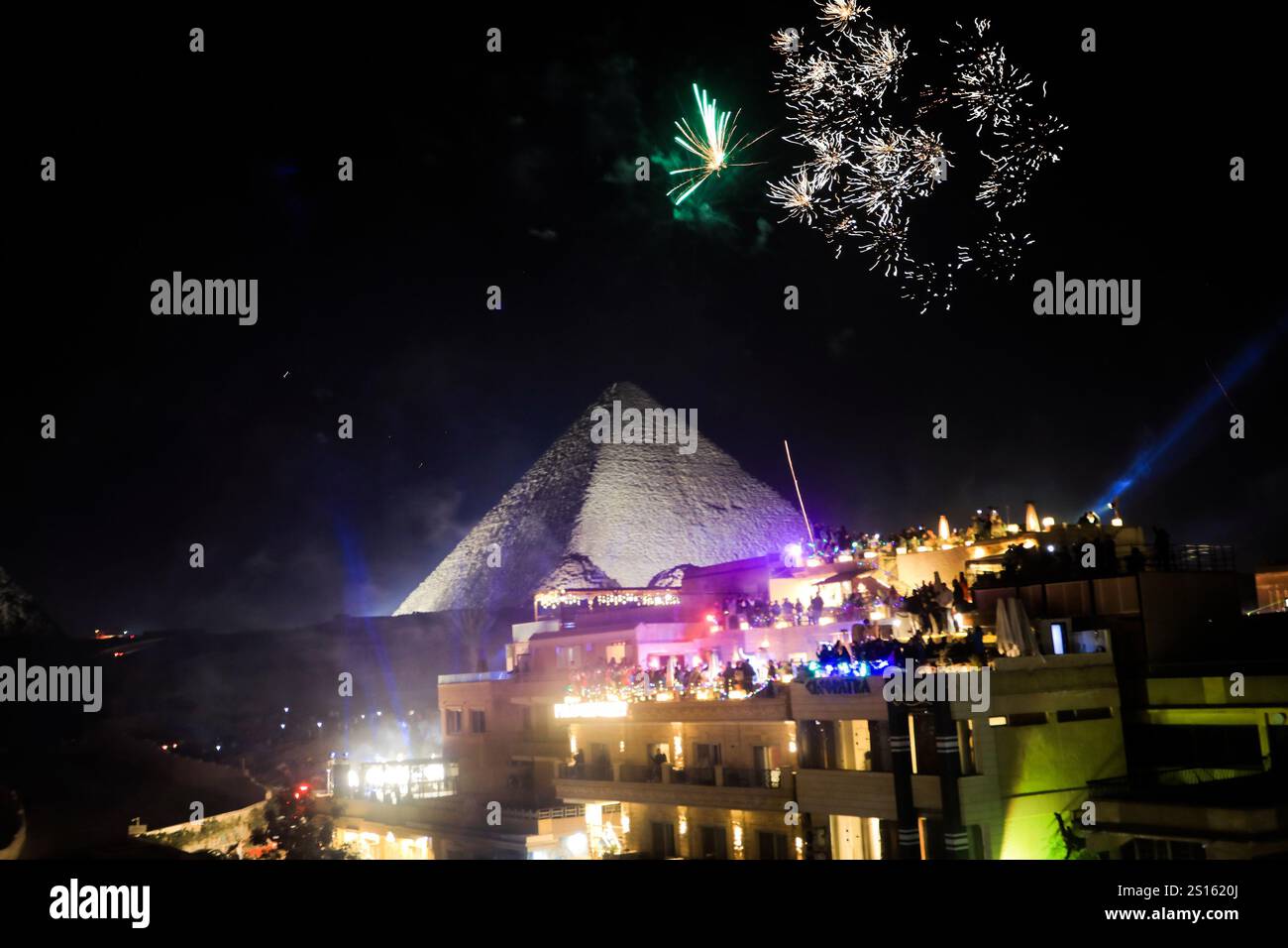 Cairo, Egypt. 31st Dec, 2024. Fireworks spark over the historical site ...