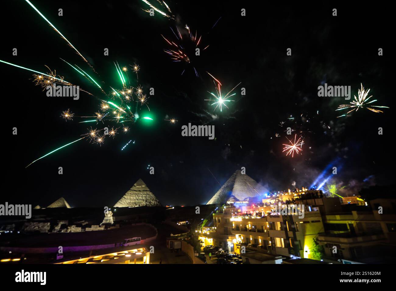 Cairo, Egypt. 31st Dec, 2024. Fireworks spark over the historical site ...