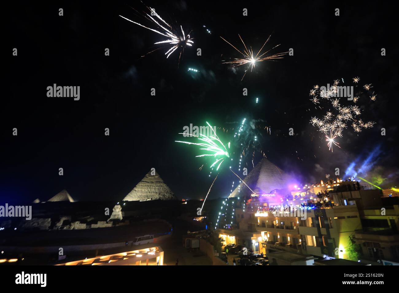 Cairo, Egypt. 31st Dec, 2024. Fireworks spark over the historical site ...