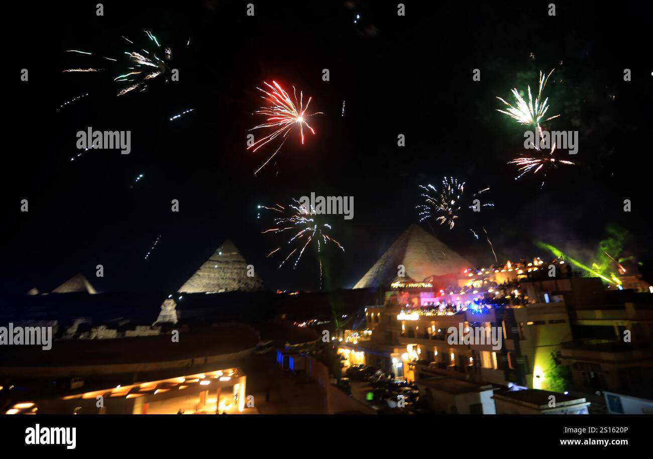 Cairo, Egypt. 31st Dec, 2024. Fireworks spark over the historical site ...