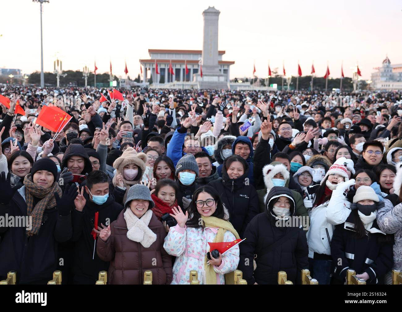 Beijing, China. 1st Jan, 2025. People hail after a grand national flag ...