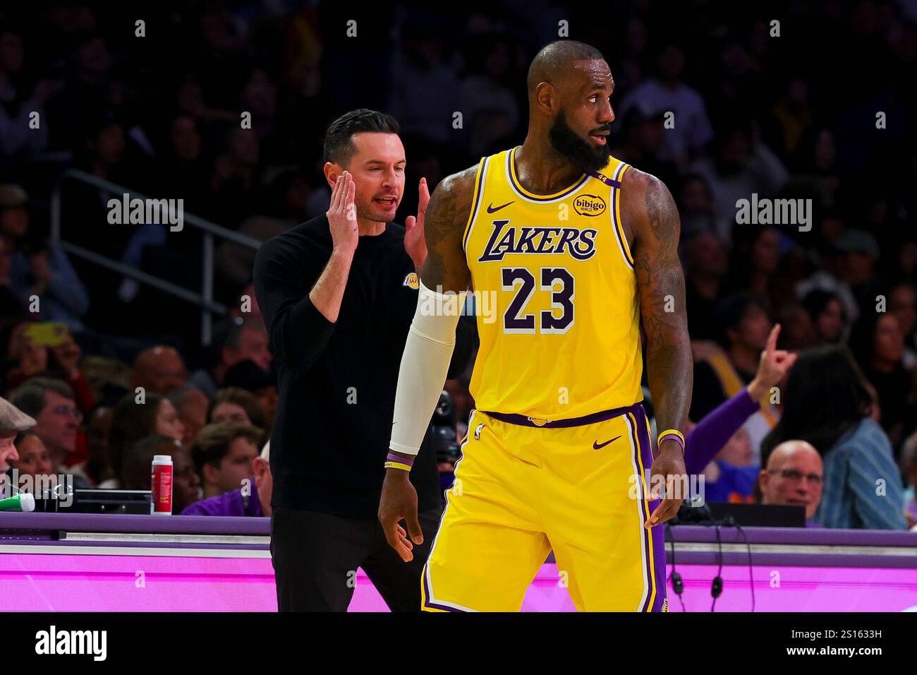 Los Angeles Lakers head coach JJ Redick, left, reacts while Lakers forward LeBron James (23 ...