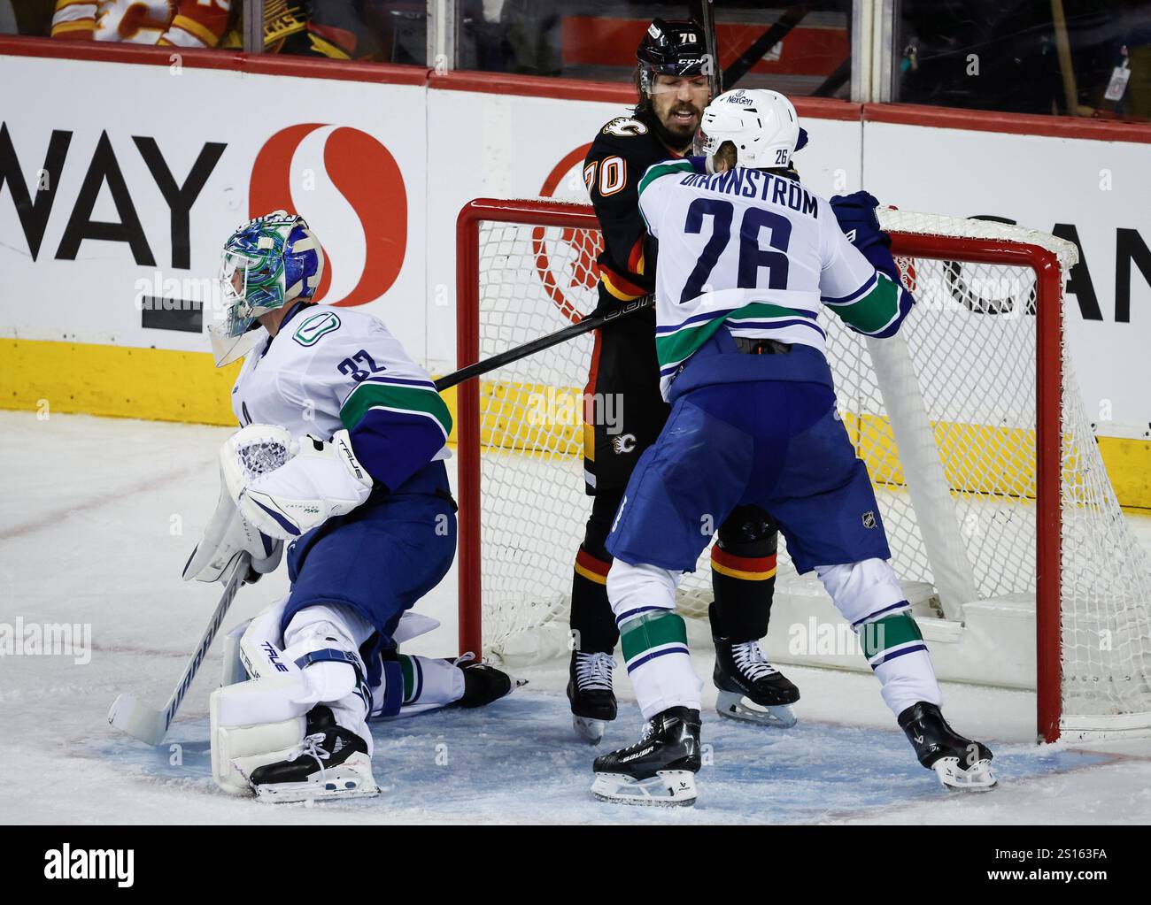 Vancouver Canucks' Erik Brannstrom, right, holds Calgary Flames' Ryan ...