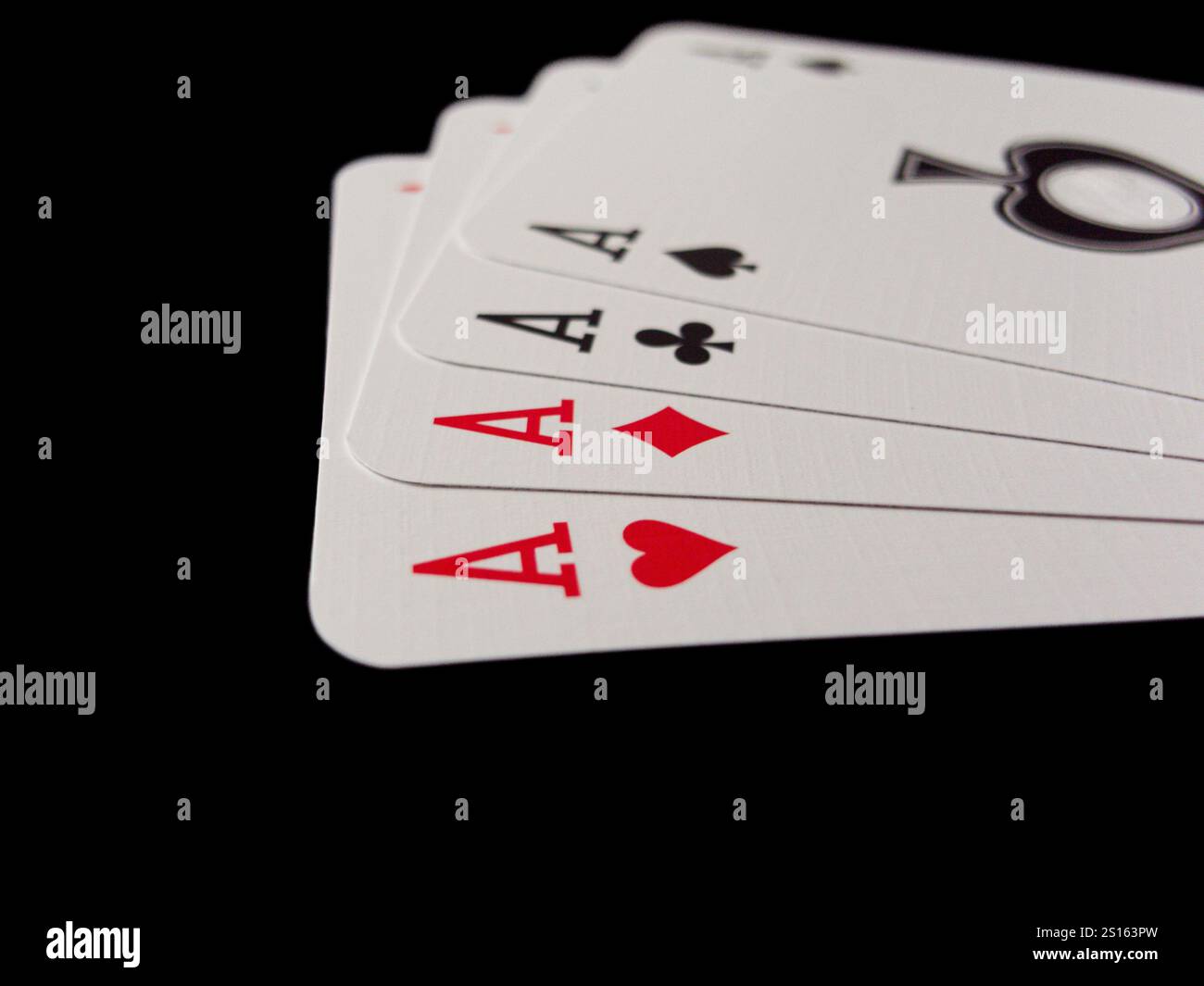 Four cards with different symbols on them. The top card has a heart ...