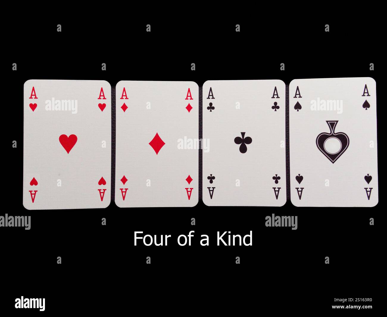 Four cards with different symbols on them. The top card has a heart ...