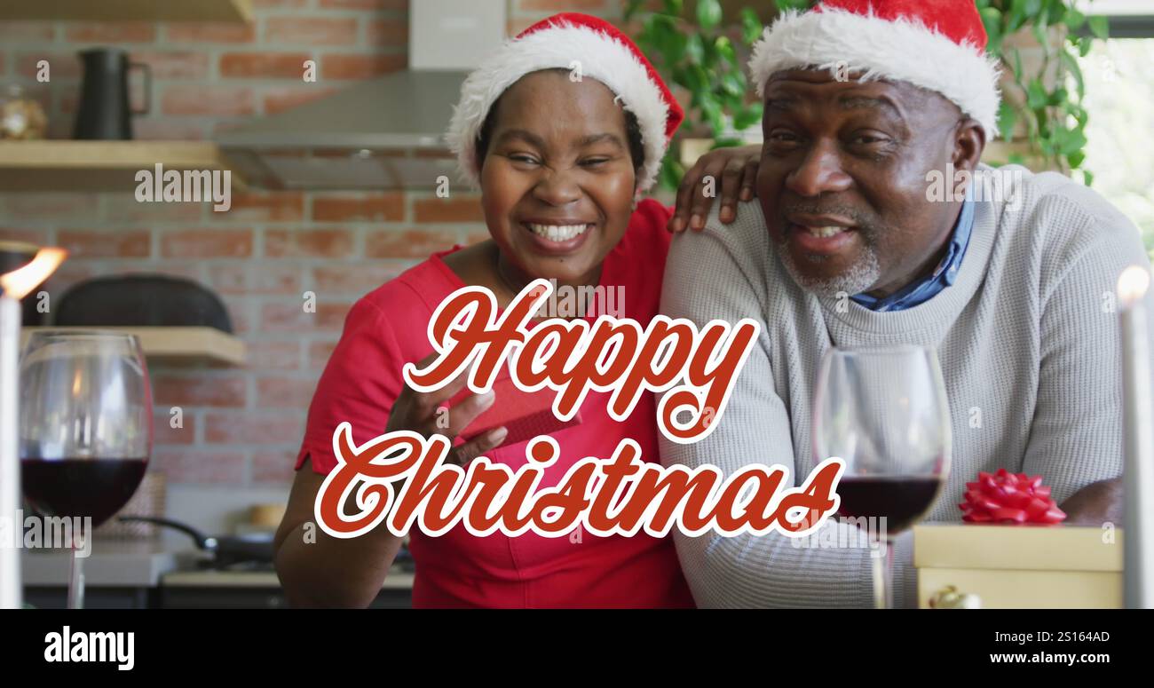 Image of christmas greetings text over african american couple in santa ...