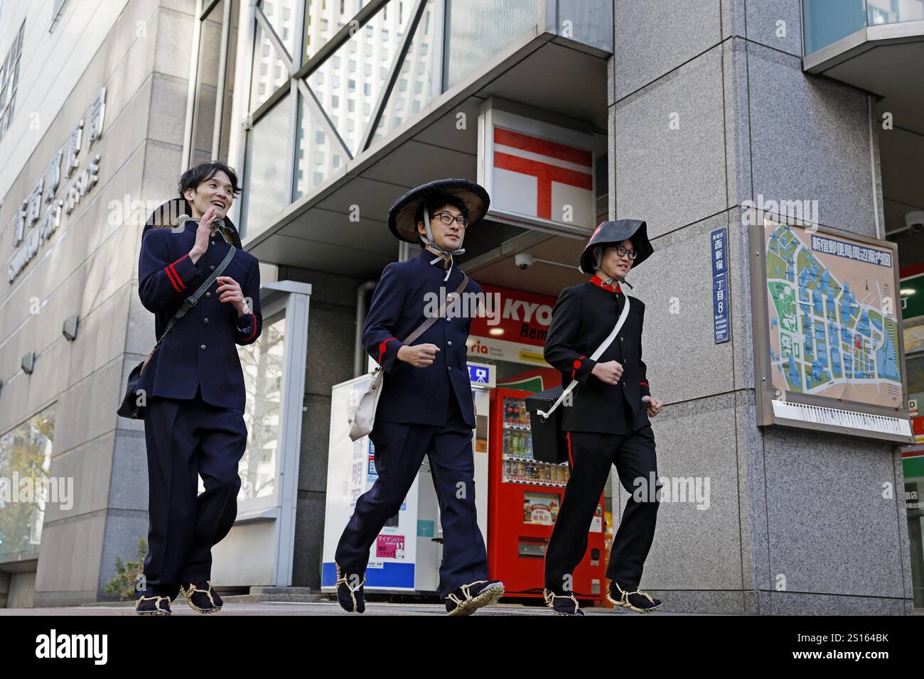 Postal workers in a uniform worn by Meiji-era mailmen depart Tokyo's ...