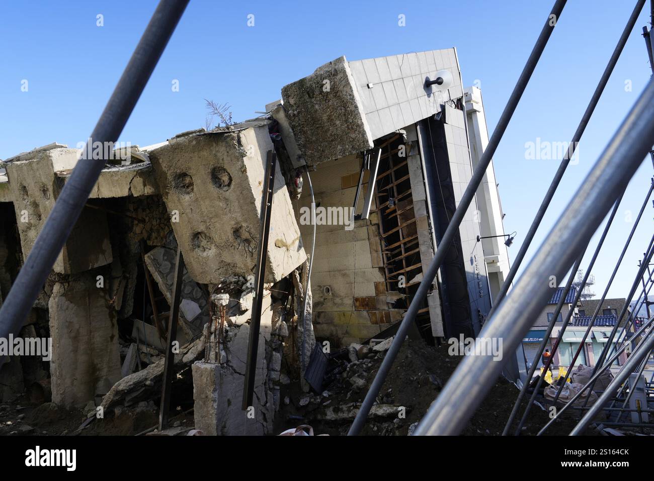 Demolition work is under way at a seven-story building in Wajima ...