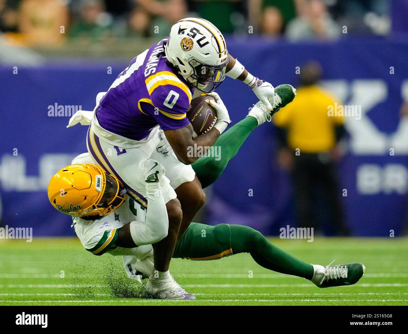 Safety Devyn Bobby (Baylor Bears, #03) hangs on to make a tackle on ...