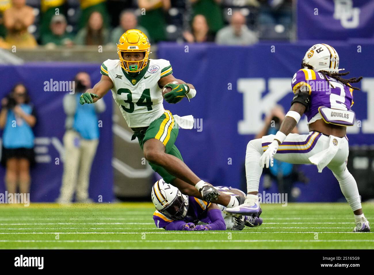 Wide receiver Josh Cameron (Baylor Bears, #34) carries the ball for a first down past the diving ...