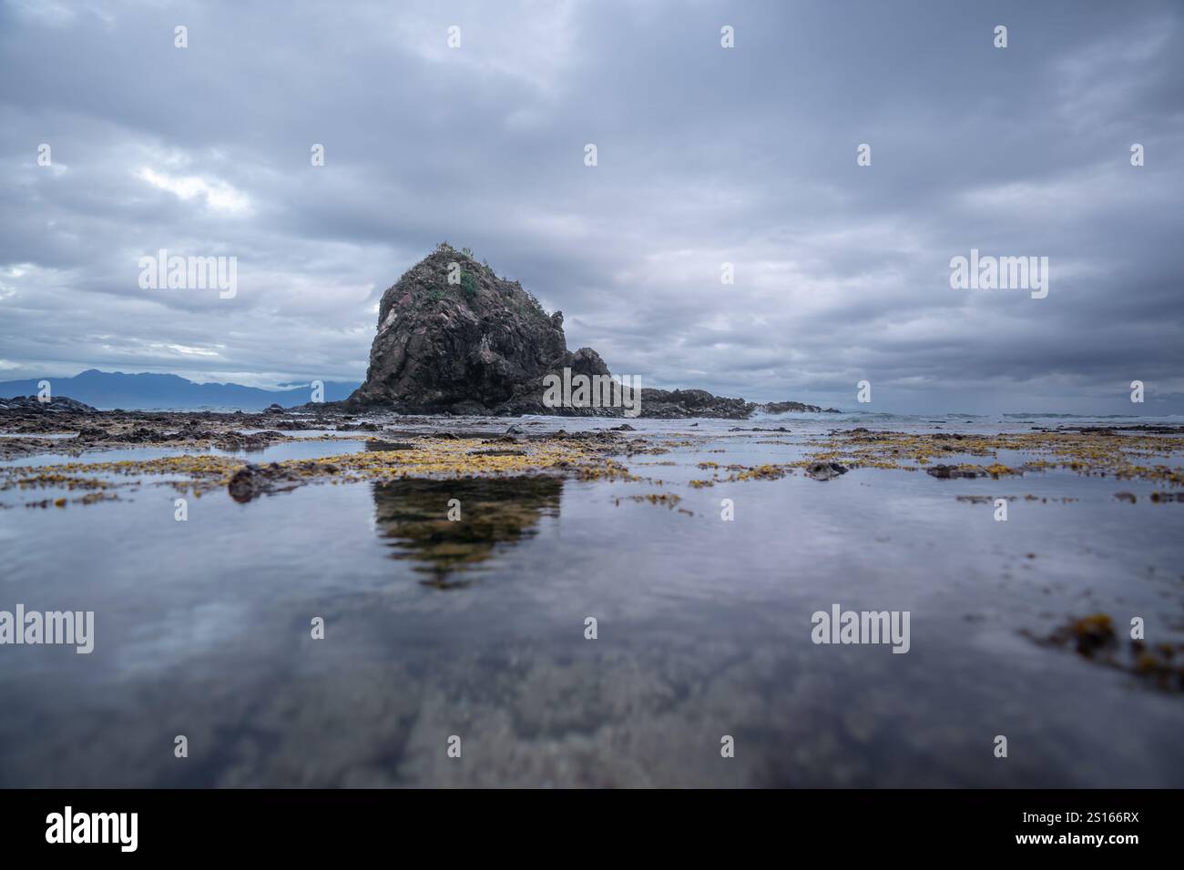 A dramatic coastal scene of Diguisit, Aurora featuring two rugged rock ...